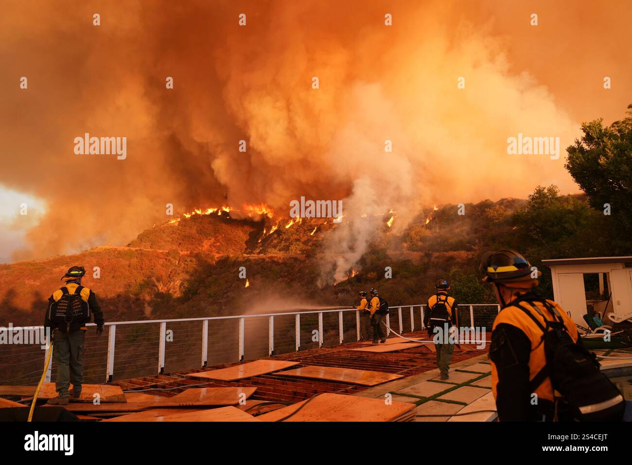 Fire crews monitor the Palisades Fire in Mandeville Canyon on Saturday ...