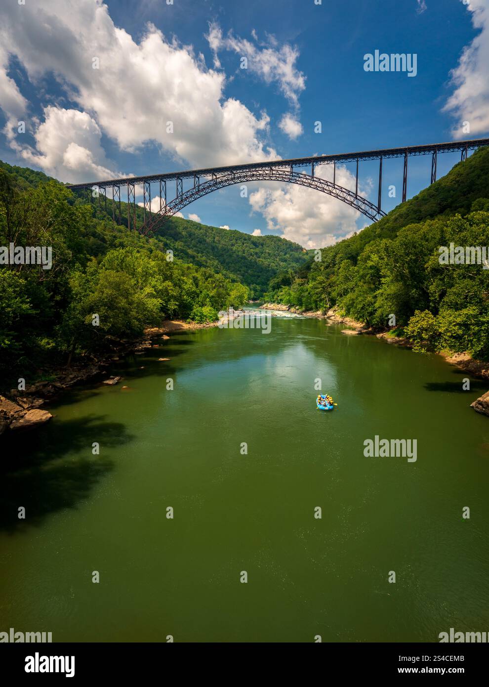 Rafters float towards the rapids under the high arched New River Gorge ...