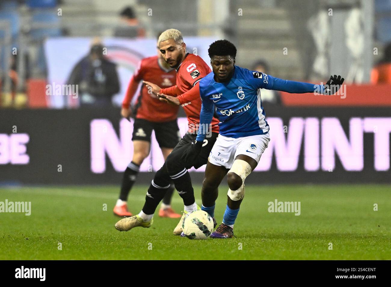 Genk, Belgium. 11th Jan, 2025. OHL's Youssef Maziz and Genk's Christopher Bonsu Baah fight for ...