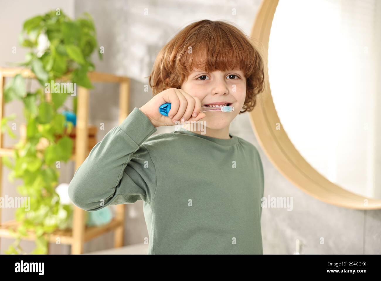 Cute boy brushing his teeth at home Stock Photo - Alamy