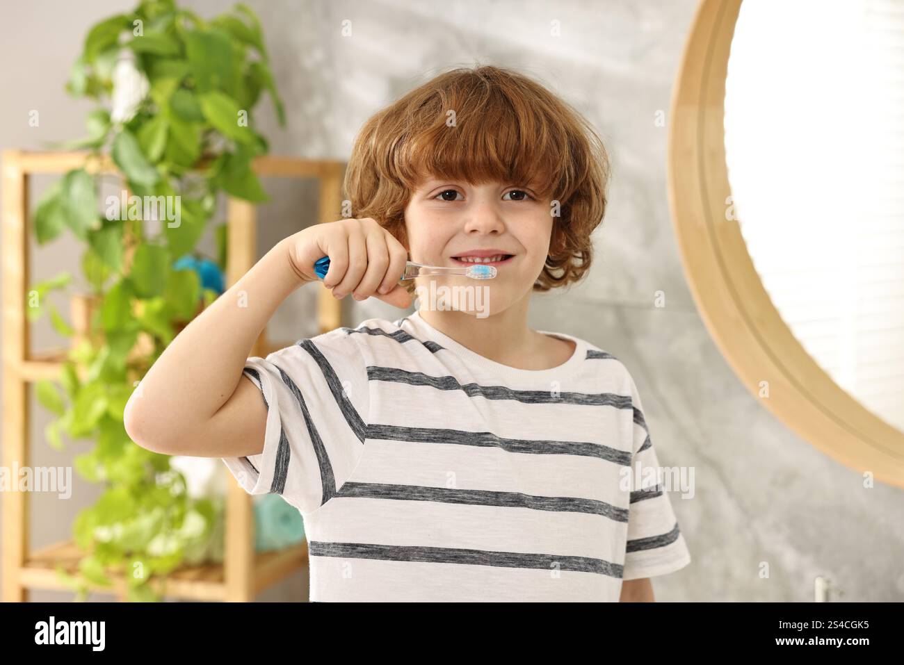 Cute boy brushing his teeth in bathroom Stock Photo - Alamy