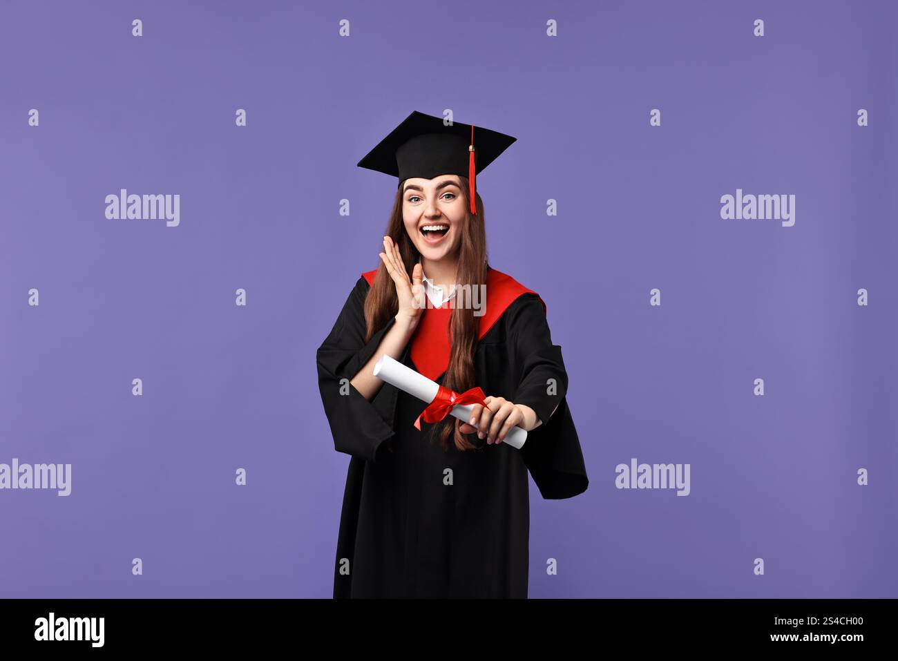 Happy student with diploma after graduation on violet background Stock ...