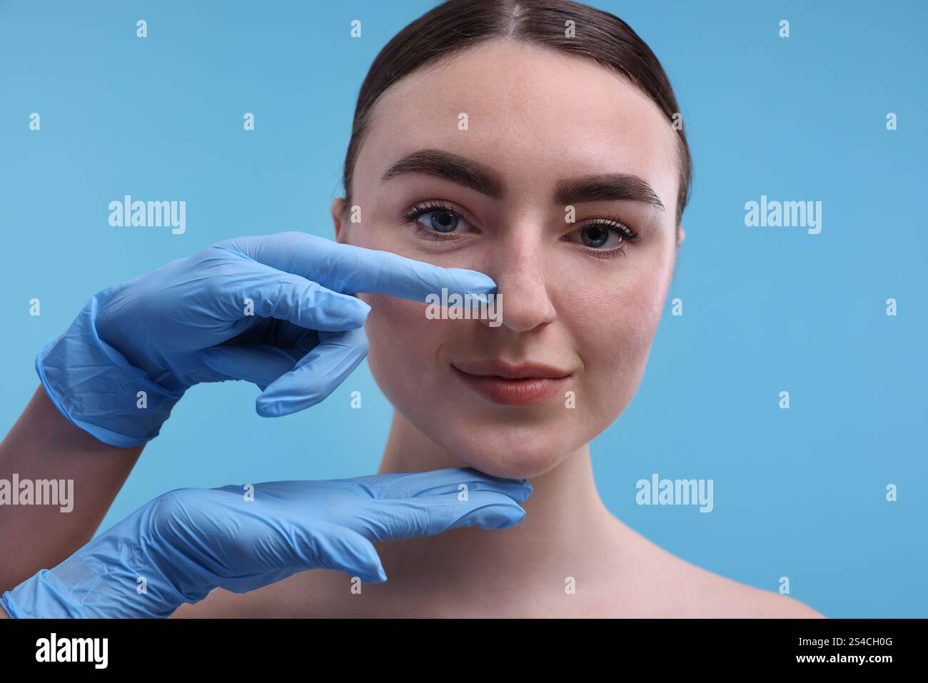Doctor checking patient's nose before plastic surgery operation on ...