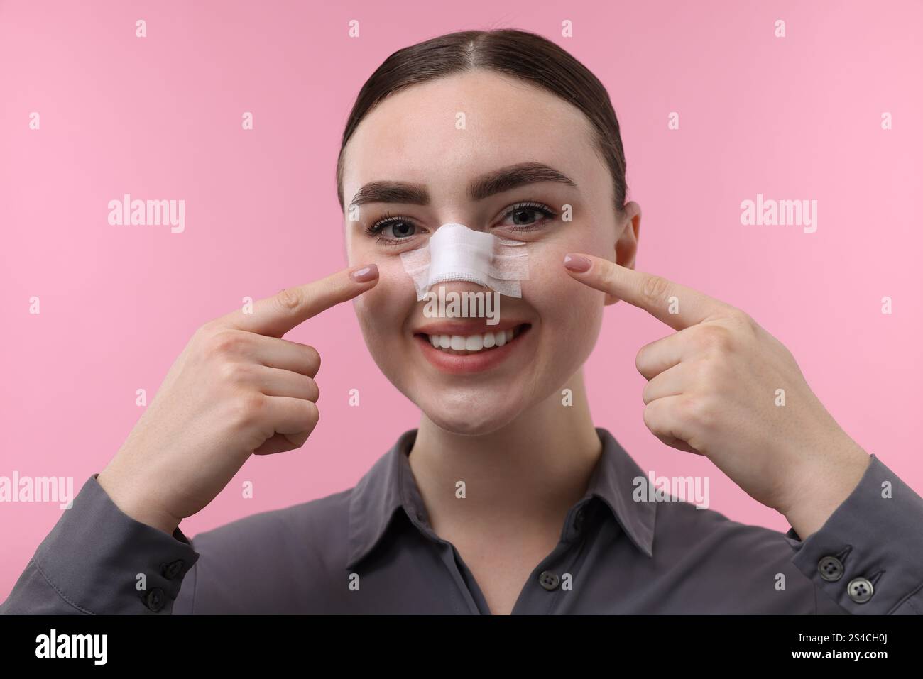 Woman with medical bandage on her nose after plastic surgery operation ...