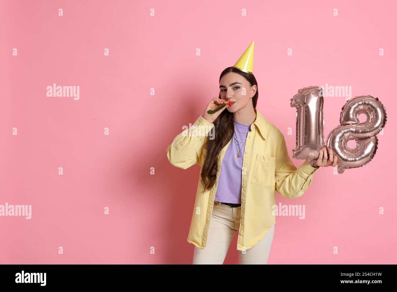 Coming of age party - 18th birthday. Happy young woman with number ...