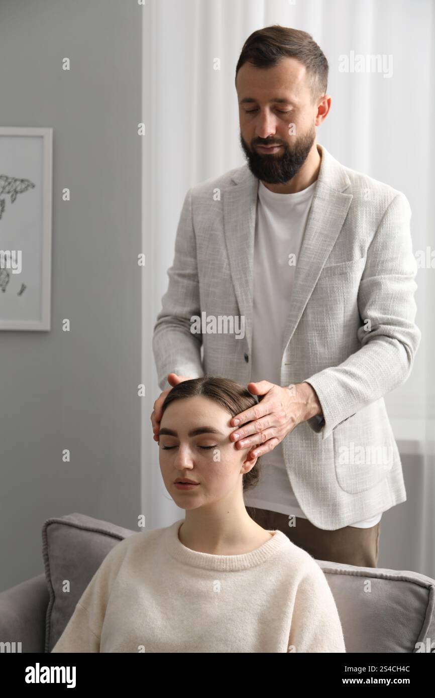 Psychologist working with patient during hypnosis session indoors Stock ...