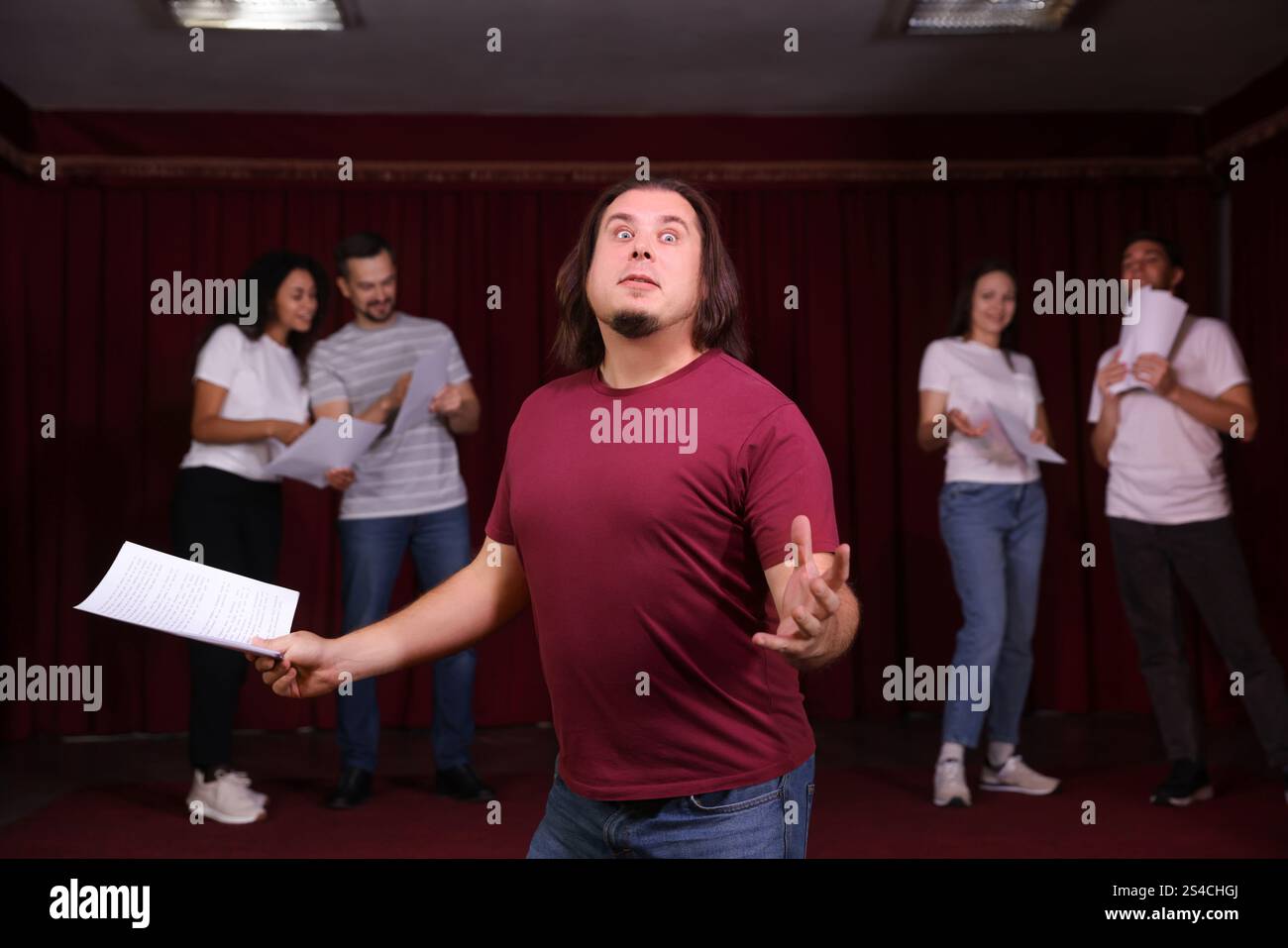 Professional actors with their scripts rehearsing in theatre Stock ...