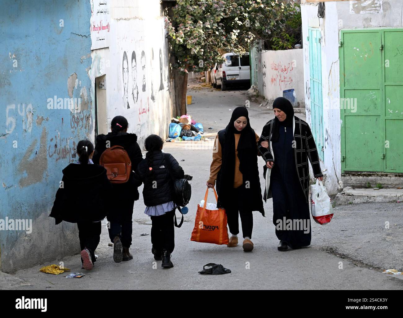 Palestinian walk in the Deheisheh Refugee Camp, where the UNRWA, United ...