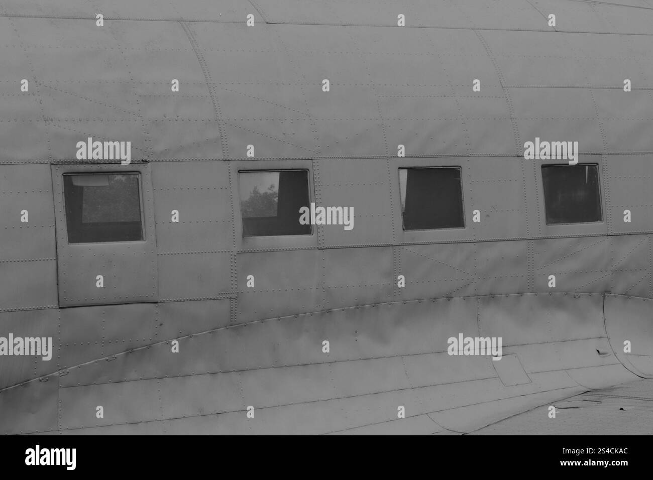 A close-up fragment of the fuselage of an old military airplane with ...