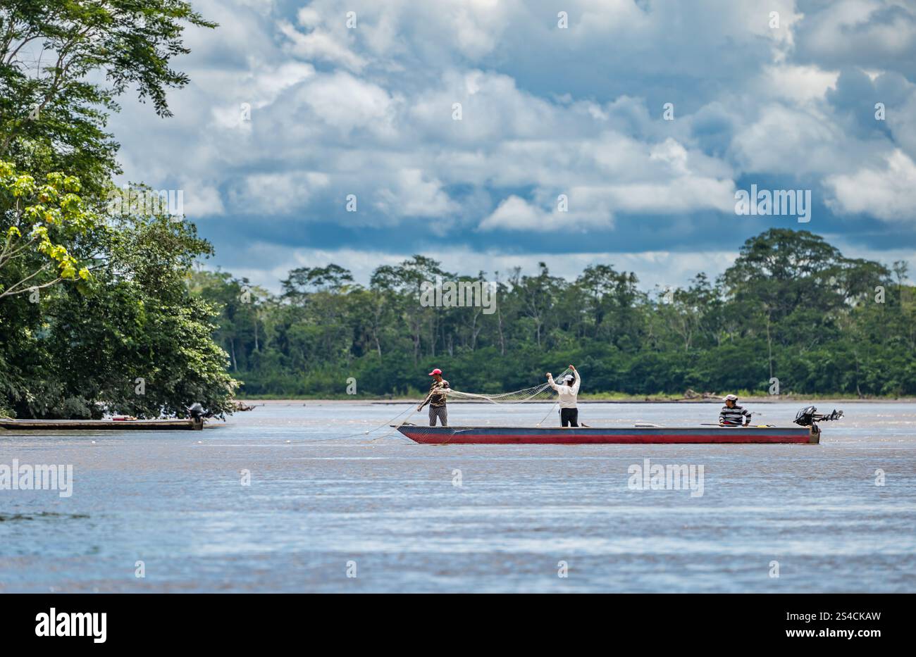 Local people in canoe longboat fishing in Napo River in the Amazon ...