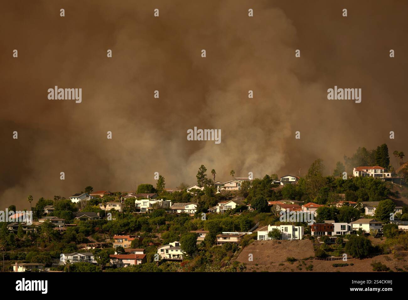 Smoke from the Palisades Fire rises over residences in Mandeville ...