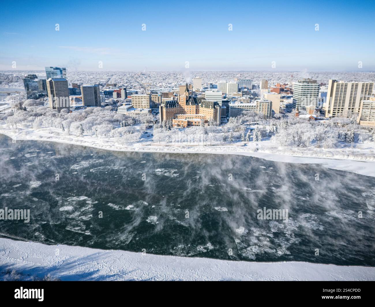 High-resolution aerial drone image of downtown Saskatoon in winter, featuring a snow-covered ...