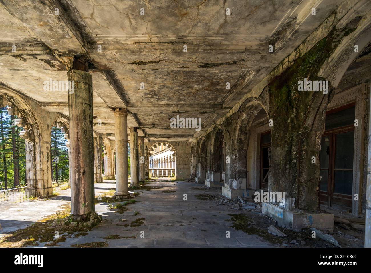 Ruined gallery with arches and weathered columns, historical elegance ...