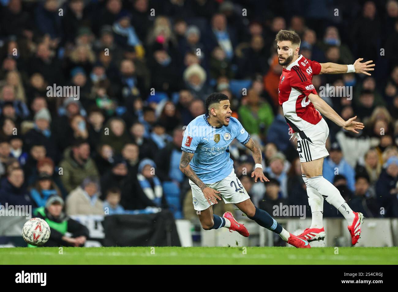 Savinho of Manchester City is tackled by Luke Garbutt of Salford City ...
