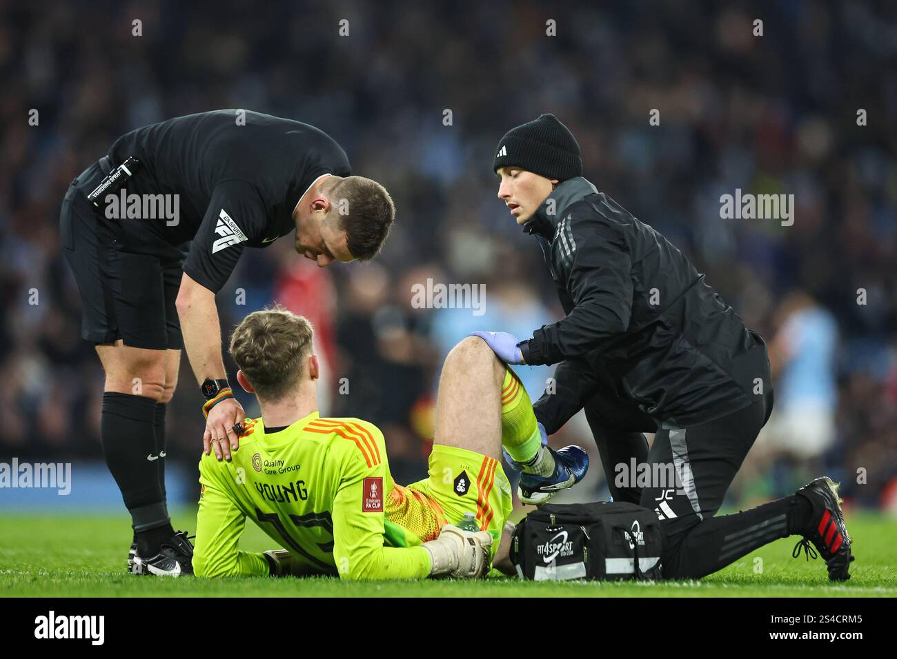 Referee Josh Smith checks on Matthew Young of Salford City as he ...