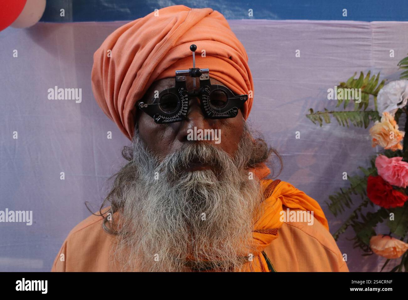 Kolkata, India. 11th Jan, 2025. A doctor examines the eye of a Sadhu or ...