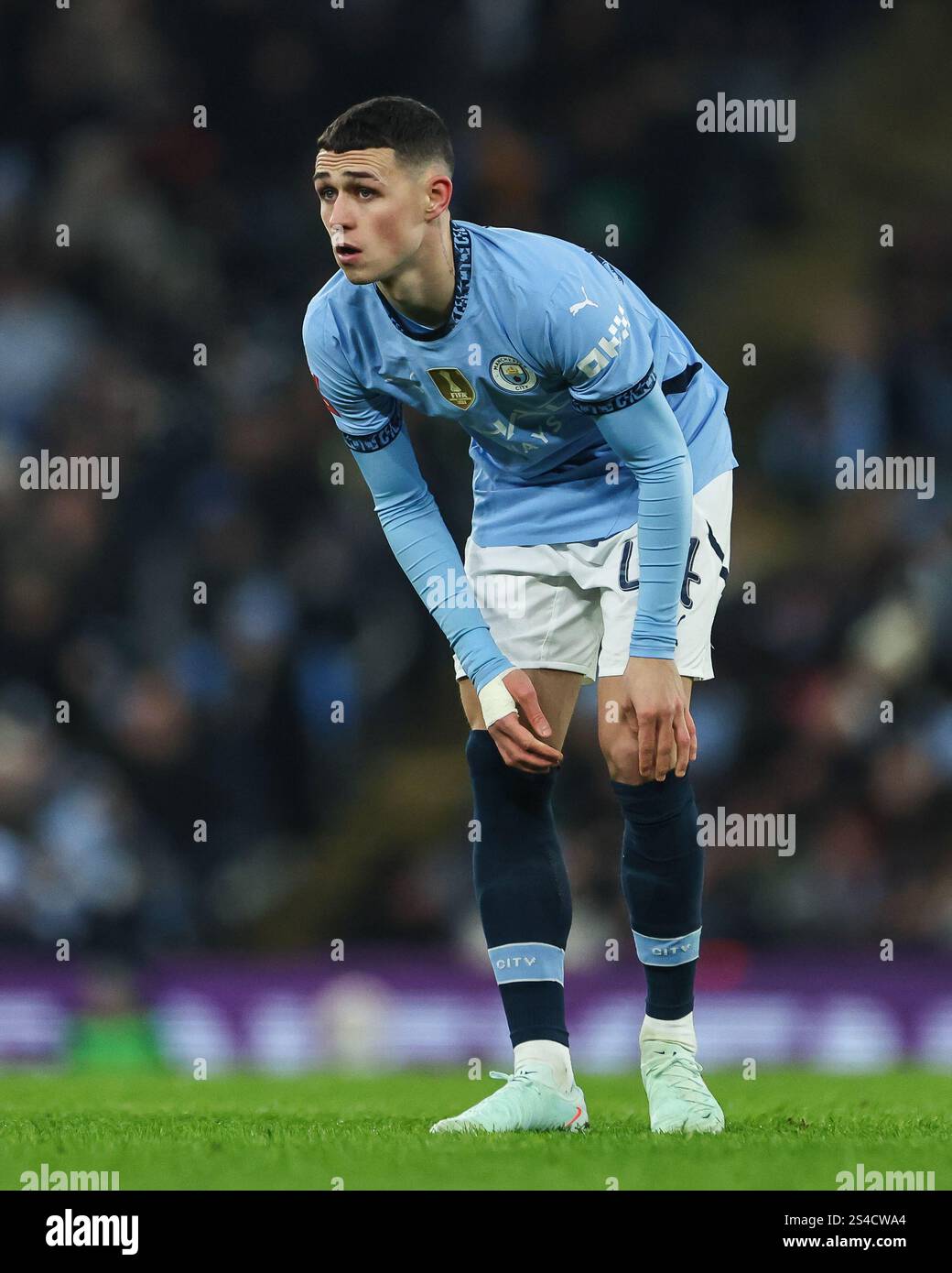 Phil Foden of Manchester City pulls his socks up during the Emirates FA ...