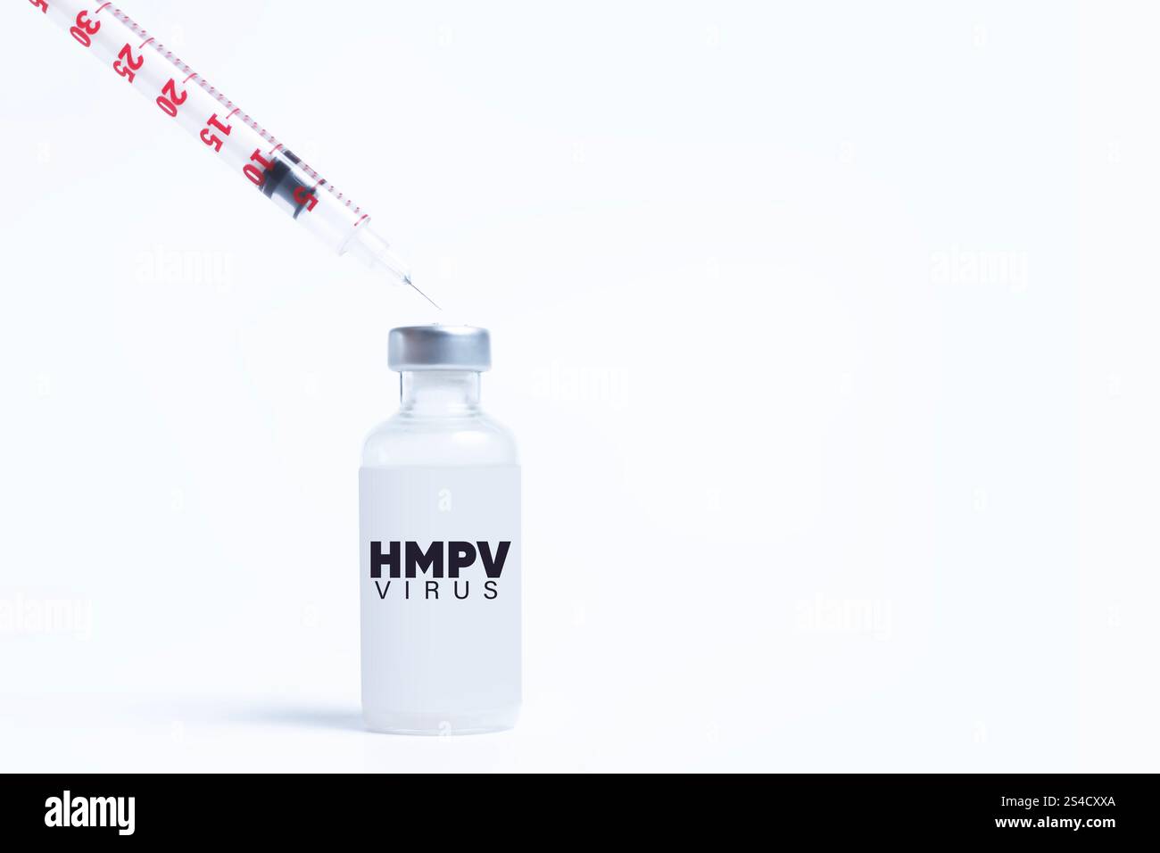 A close-up of a medical vial labeled HMPV Virus, with a syringe ...