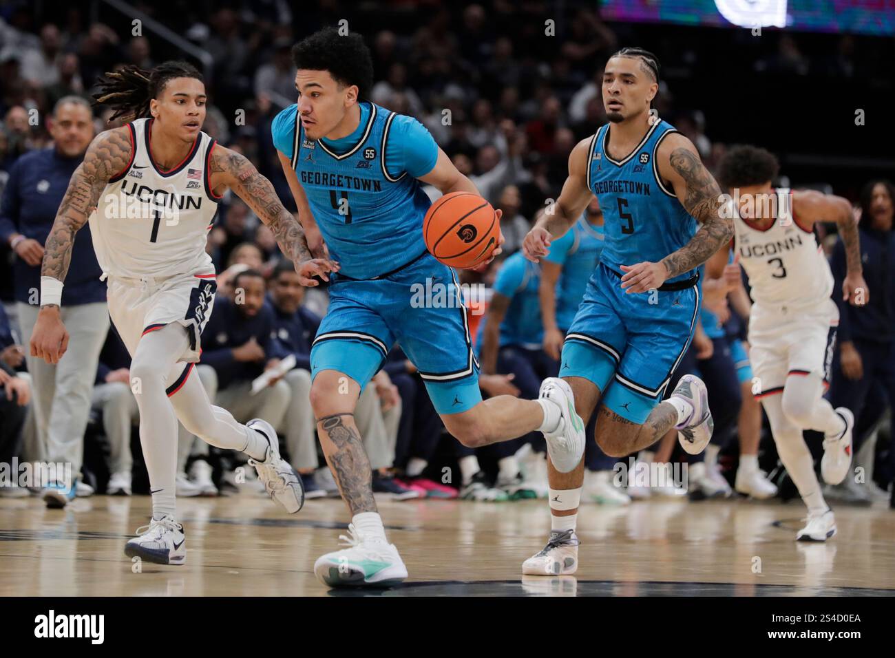 Georgetown's Caleb Williams (4) moves the ball as Connecticut's Solo ...