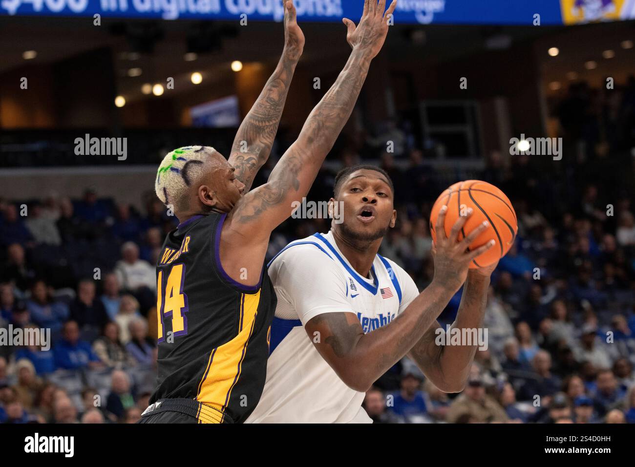 East Carolina forward C.J. Walker (14) defends Memphis forward Dain Dainja (42) during the first ...