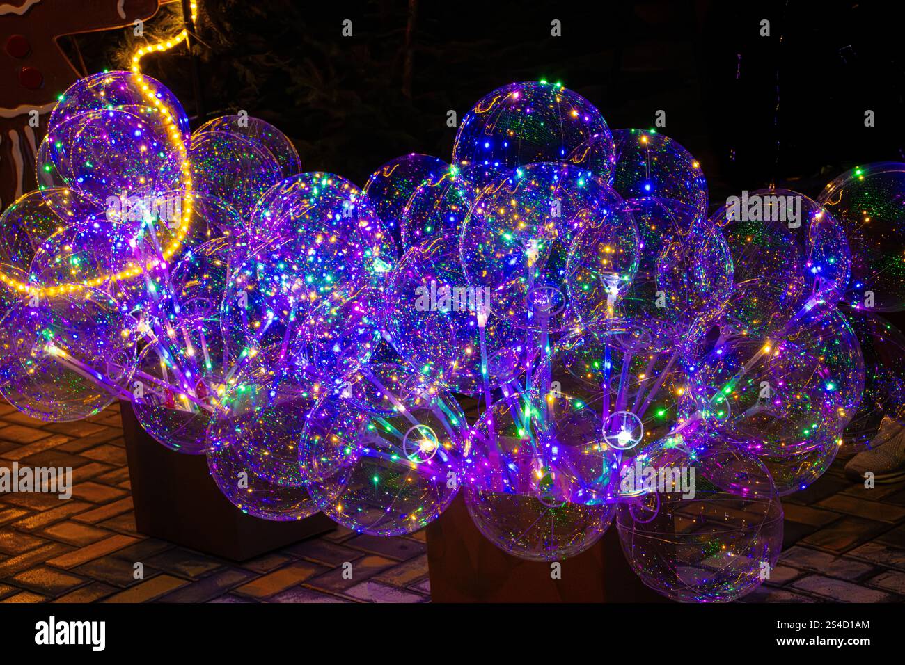 Sparkly led transparent balloons in the night. Balloons with a string ...