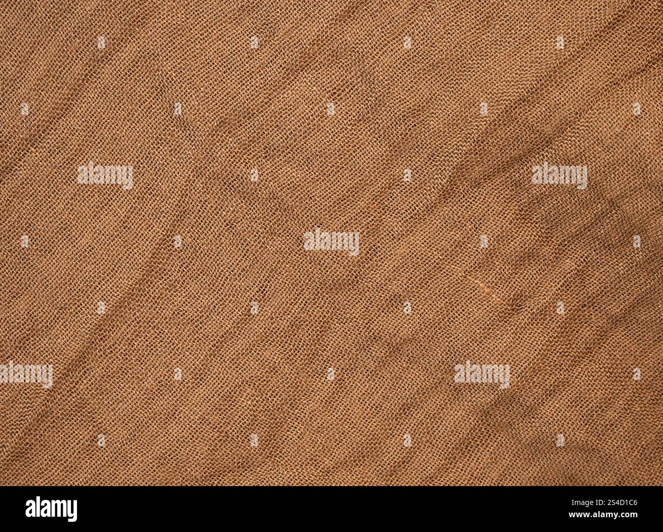 This fabric displays a rich texture and warm brown tones with subtle ...
