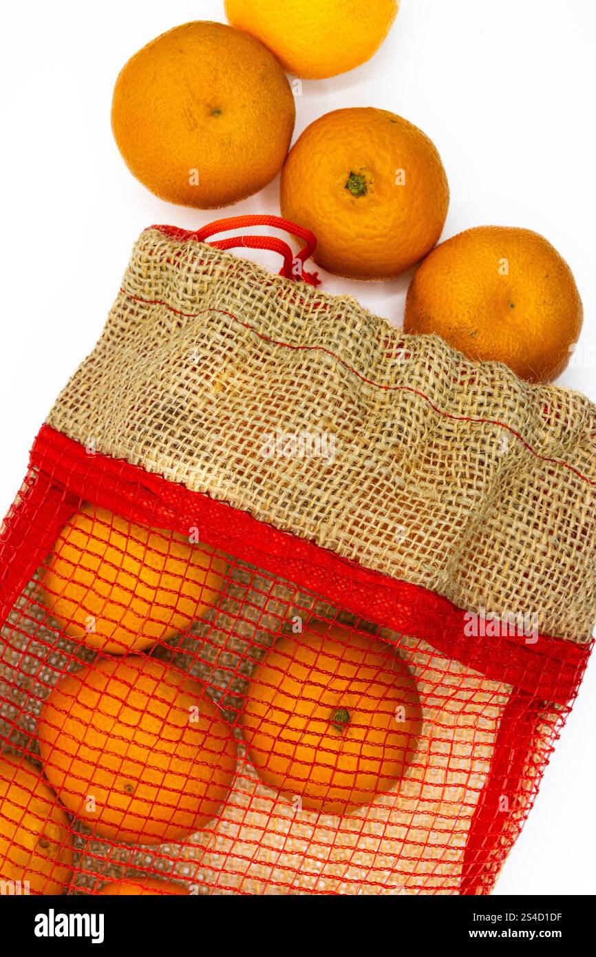 Delicious mandarins in a jute bag on a white background Stock Photo - Alamy
