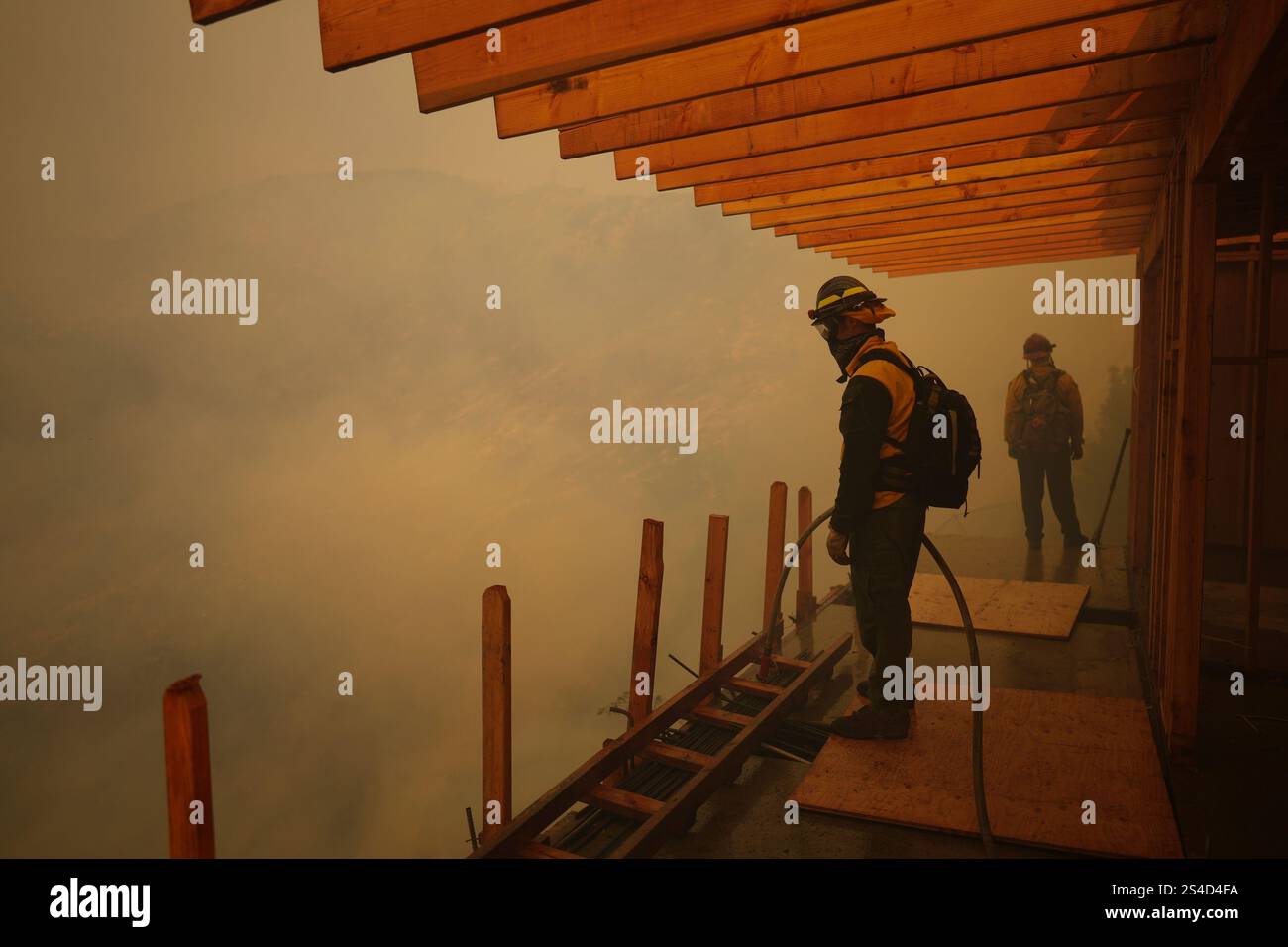 Firefighters monitor the advance of the Palisades Fire in Mandeville ...