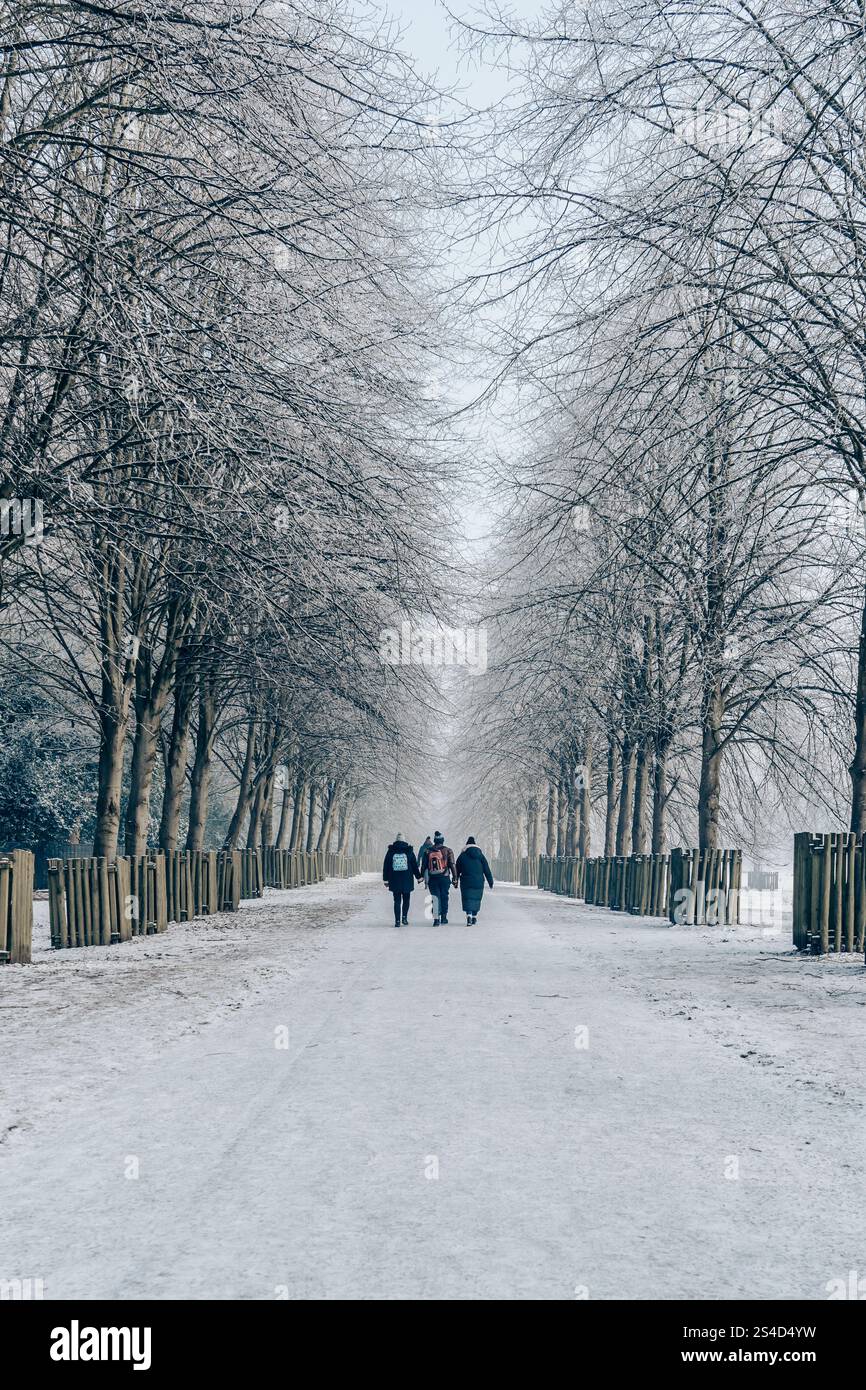 People walking in the snow and ice at National Trust Dunham, Massey ...