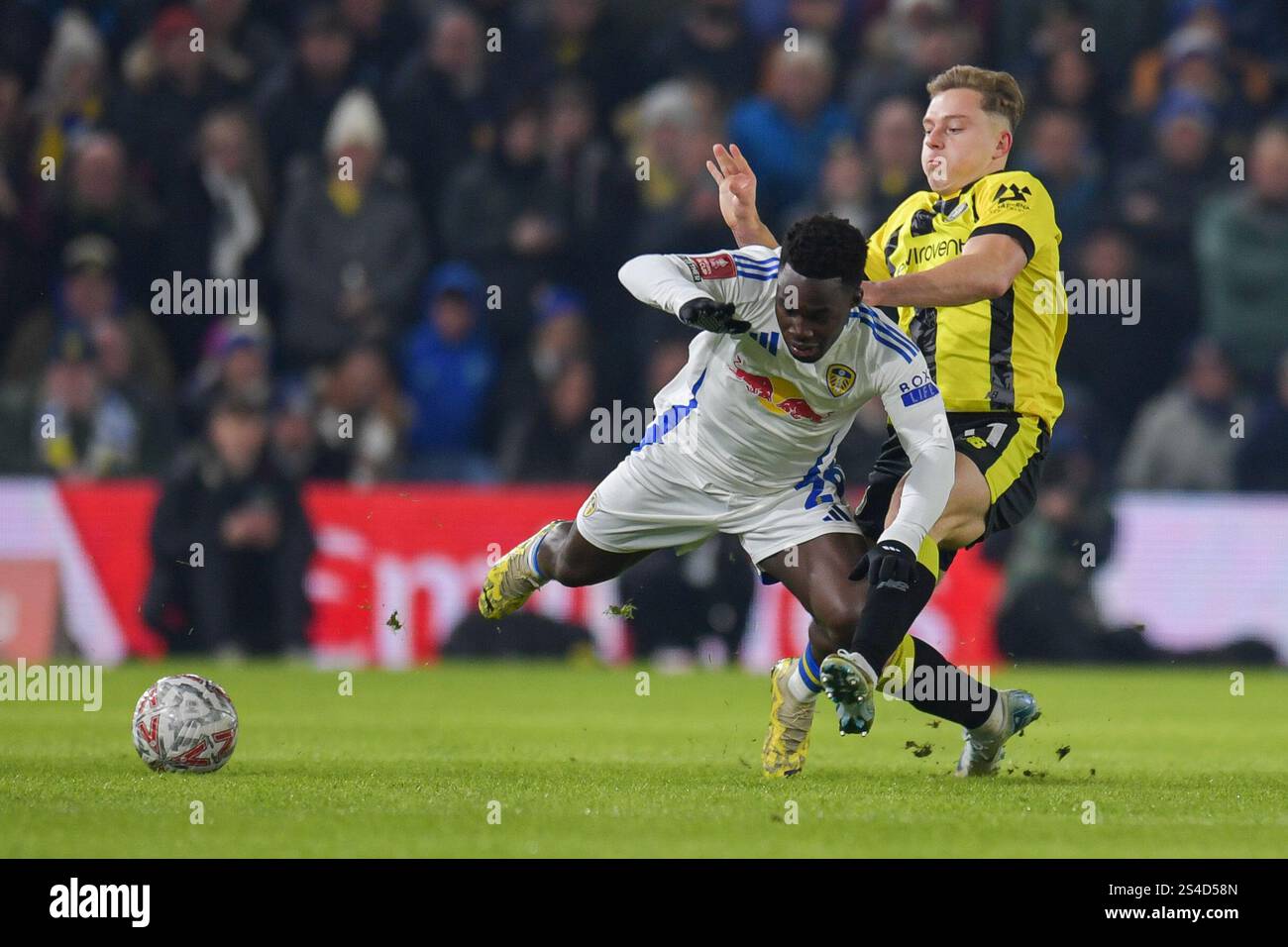 Harrogate Town's Levi Sutton tackles Leeds United's Wilfried Gnonto ...