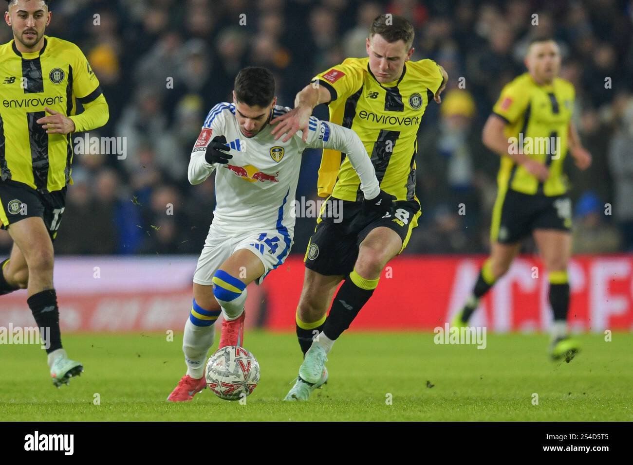 Harrogate Town's Bryn Morris looks to make a tackle on Leeds United's ...