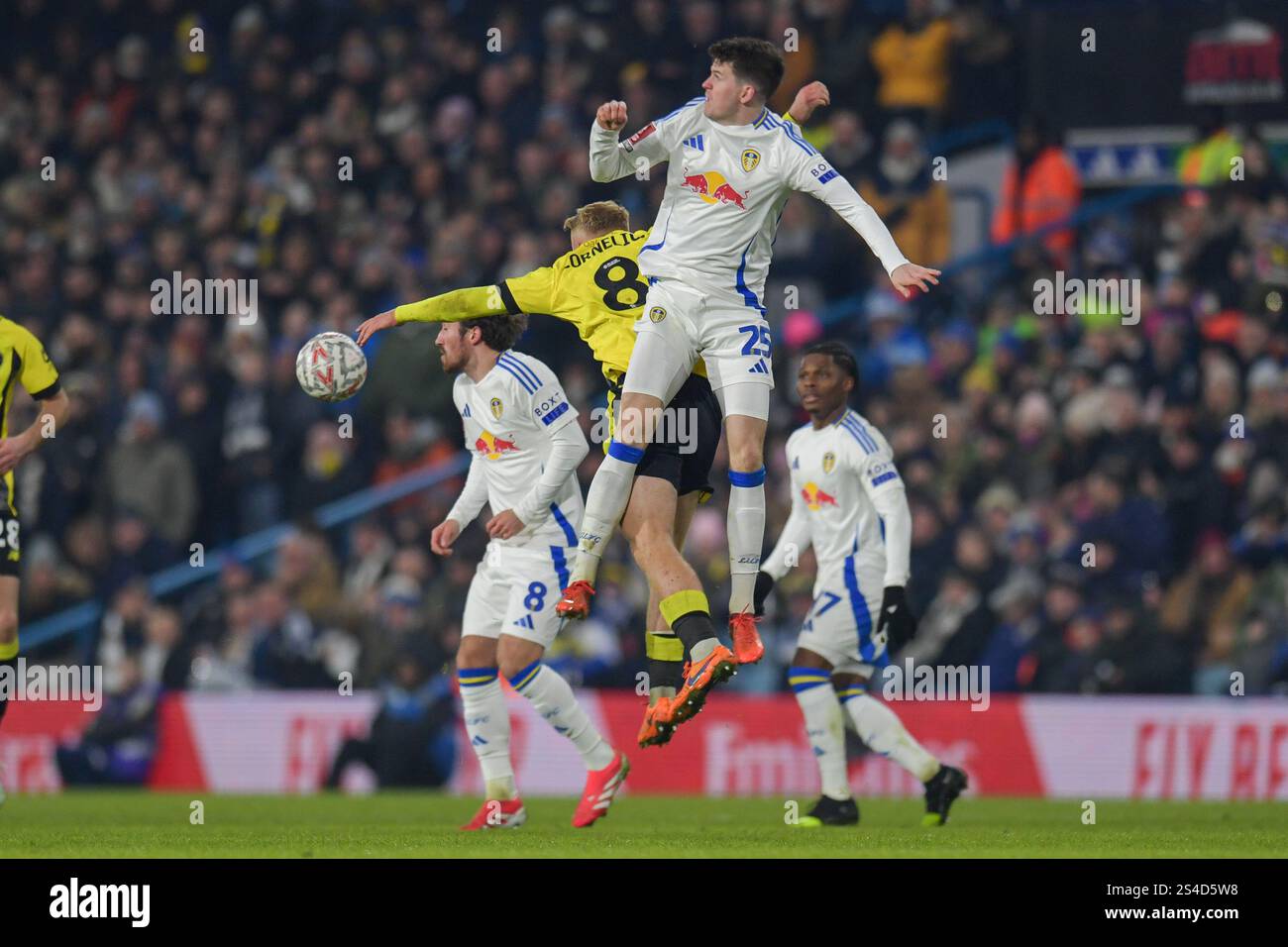Leeds United's Sam Byram out jumps Harrogate Town's Dean Cornelius to ...