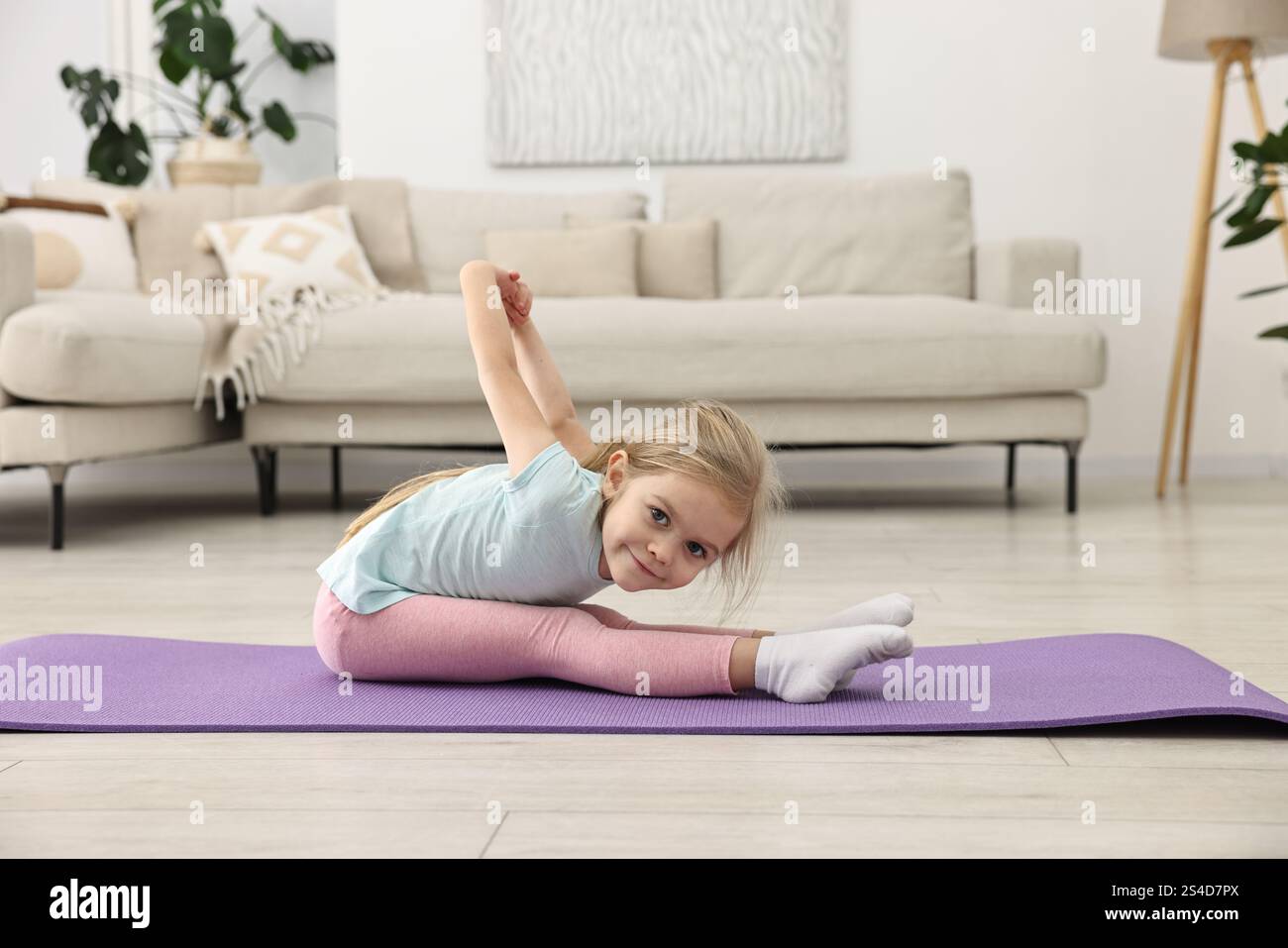 Little girl exercising on fitness mat at home. Sport activity Stock ...