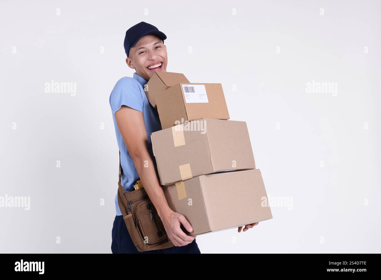 Happy postman with parcels on white background Stock Photo - Alamy
