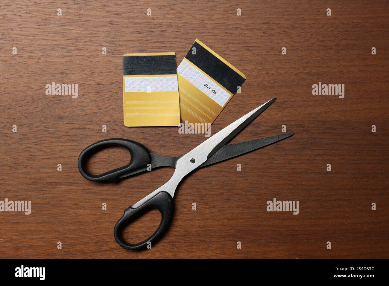 Pieces of cut credit card and scissors on wooden table, top view Stock ...