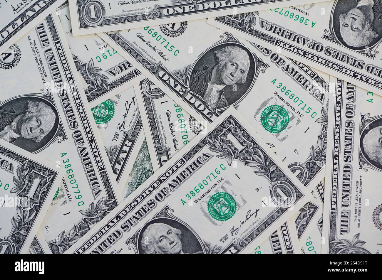 A multitude of one dollar bills are placed haphazardly, creating a ...