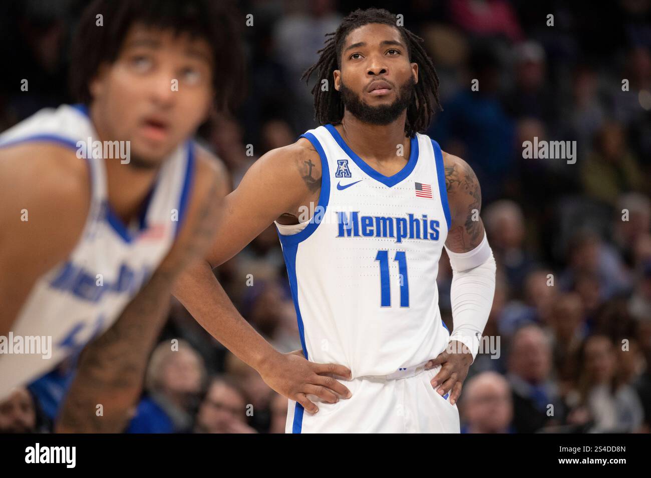 Memphis guards PJ Haggerty and Tyrese Hunter (11) watch a free throw ...