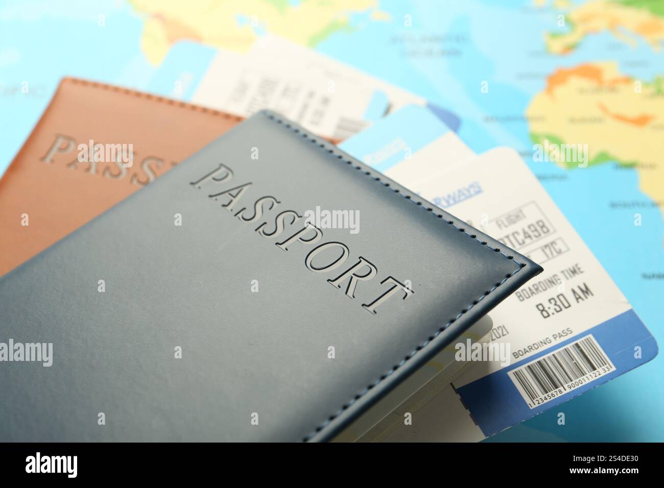 Passports with tickets on world map, closeup Stock Photo - Alamy