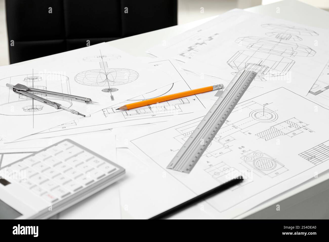 Different engineering drawings and tools on table in office Stock Photo ...