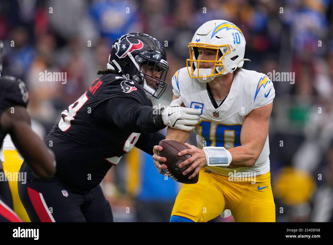 Los Angeles Chargers quarterback Justin Herbert (10) is pressured by ...