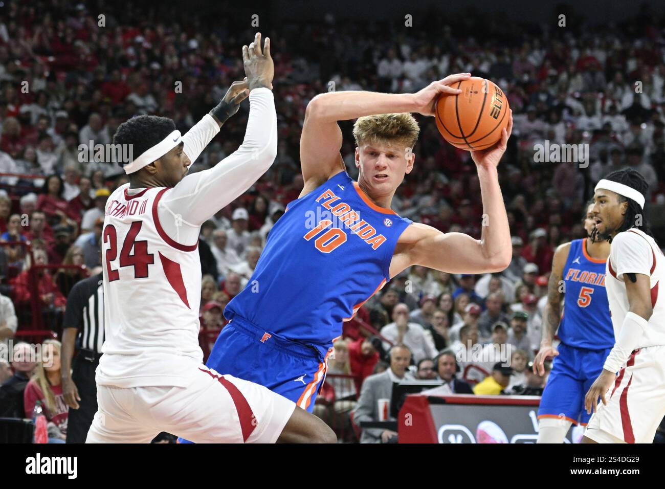 Florida forward Thomas Haugh (10) tries to get past Arkansas forward ...