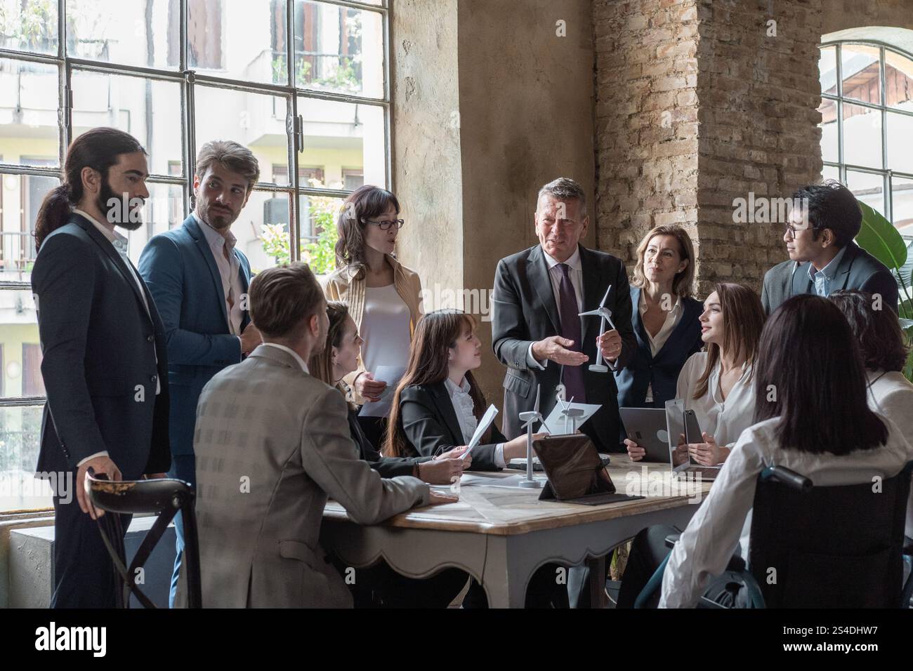 Diverse business team collaborating on a sustainable energy project ...