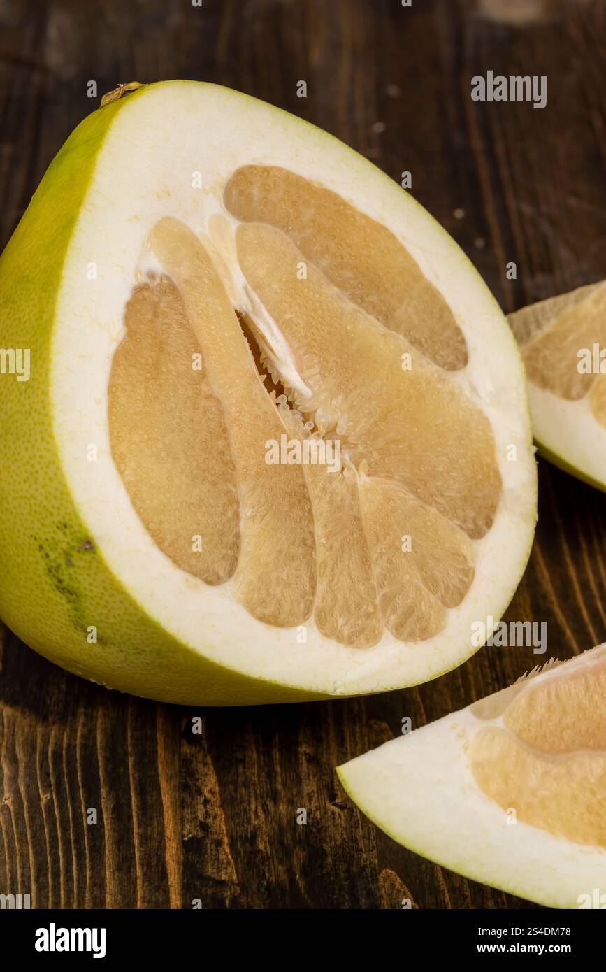 ripe pomelo with lots of pulp cut into pieces, huge juicy citrus close ...