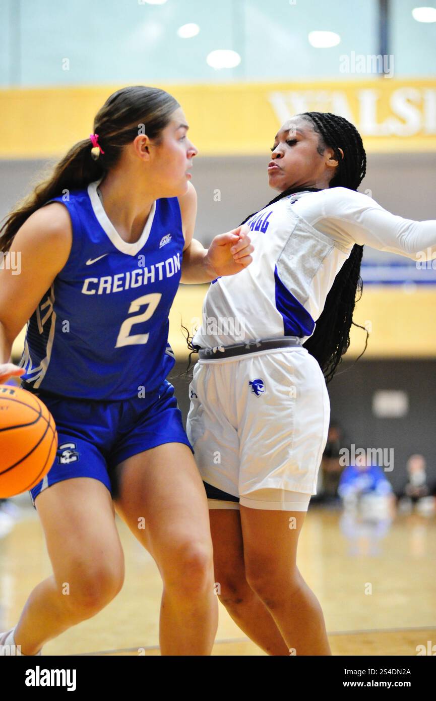 South Orange, USA. 11th Jan, 2025. Creighton's Kennedy Townsend (2) drives past Jada Eads (0 ...