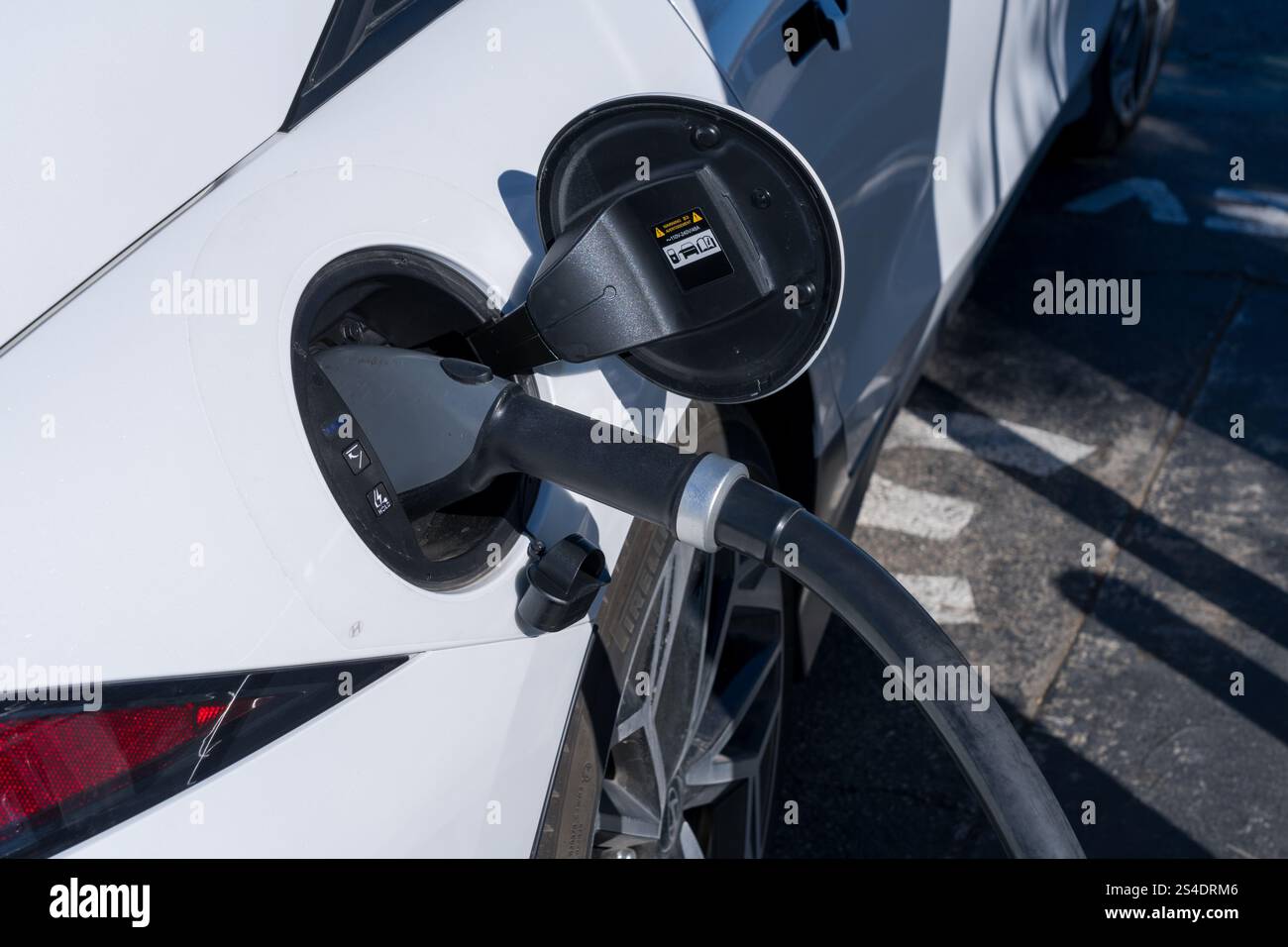 Modern electric car connected to DC high speed charger at public ...