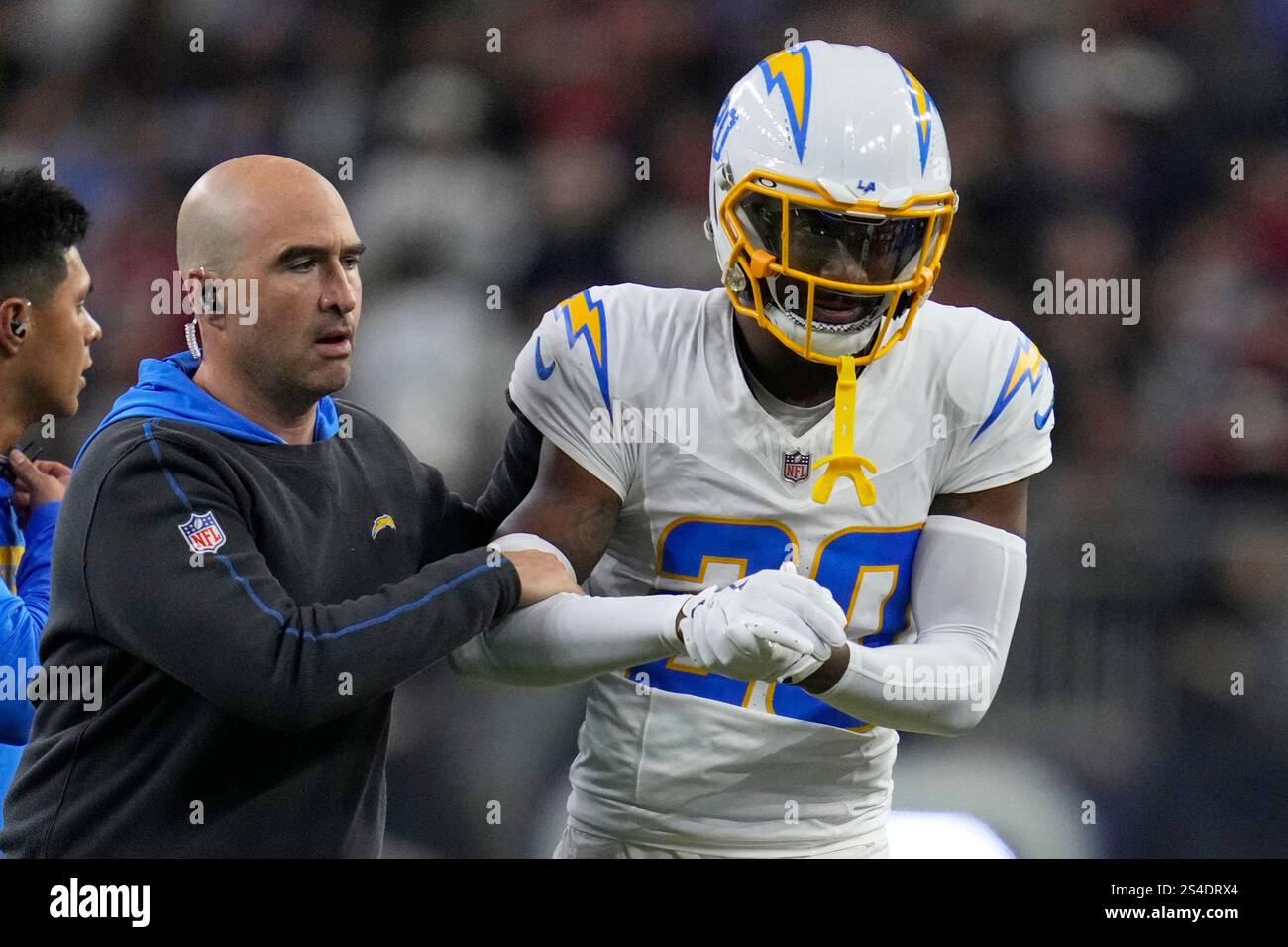 Los Angeles Chargers' Cam Hart (20) is helped off the field after being ...
