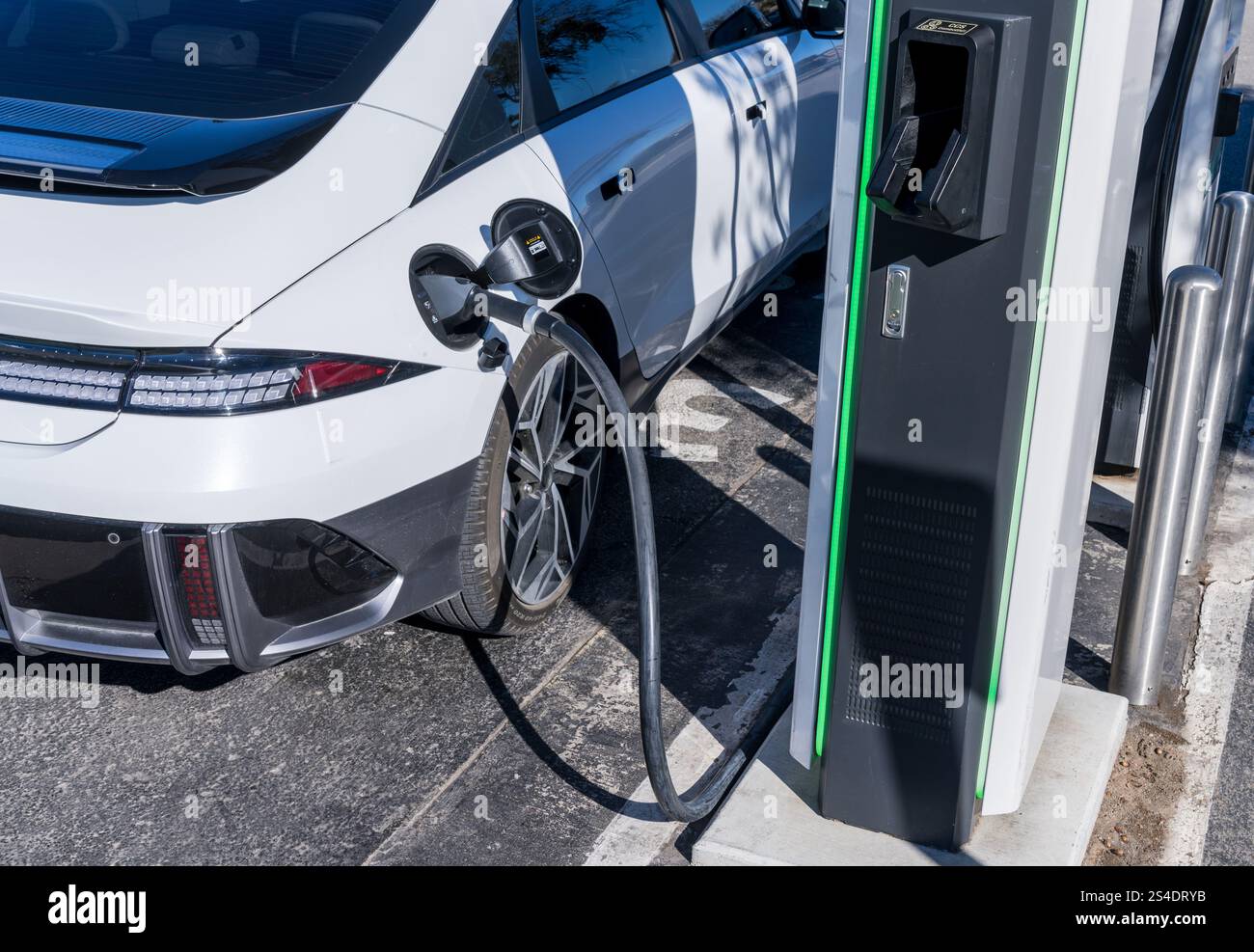 Modern electric car connected to DC high speed charger at public ...