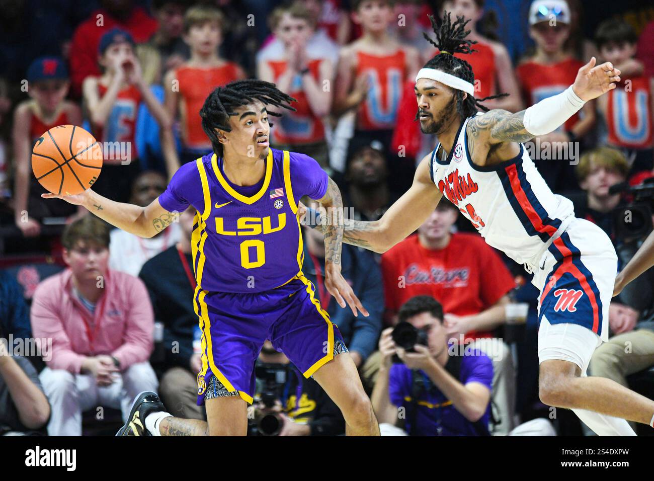 LSU guard Vyctorius Miller (0) is defended by Mississippi guard Dre ...