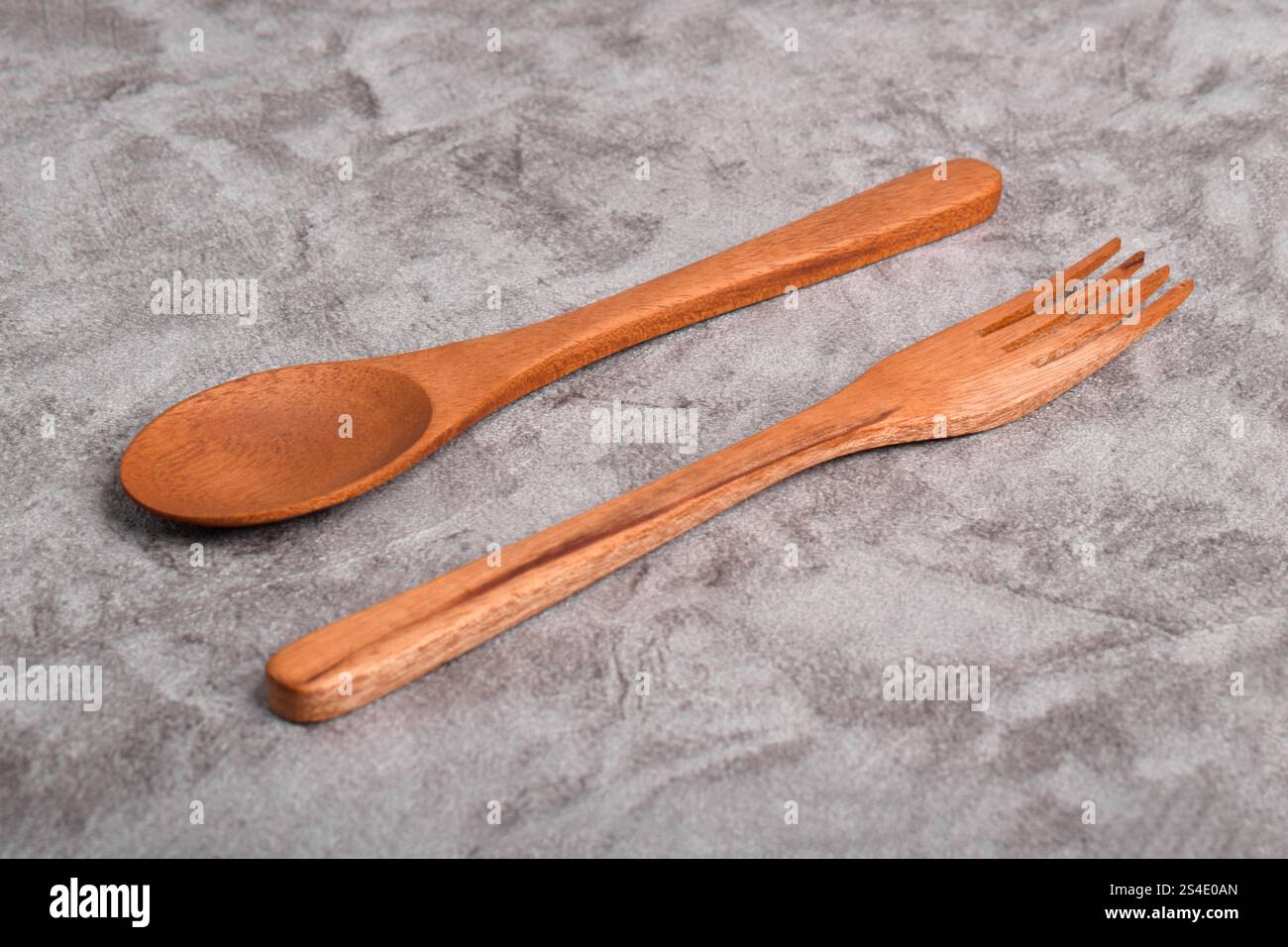 Wooden spoon and fork on table. A set of kitchen utensils Stock Photo ...