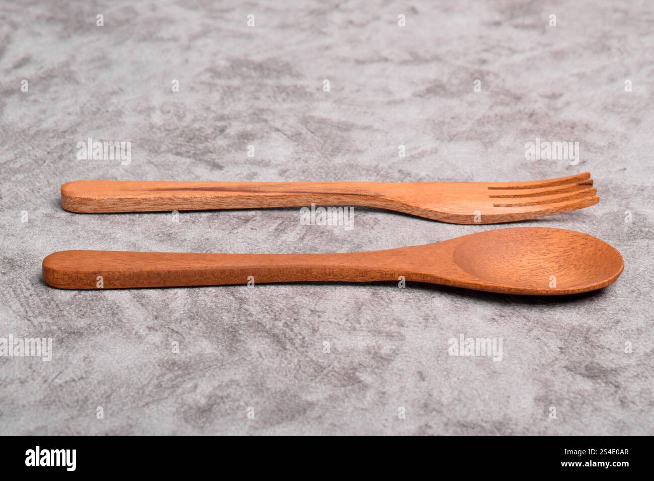 Wooden spoon and fork on table. A set of kitchen utensils Stock Photo ...
